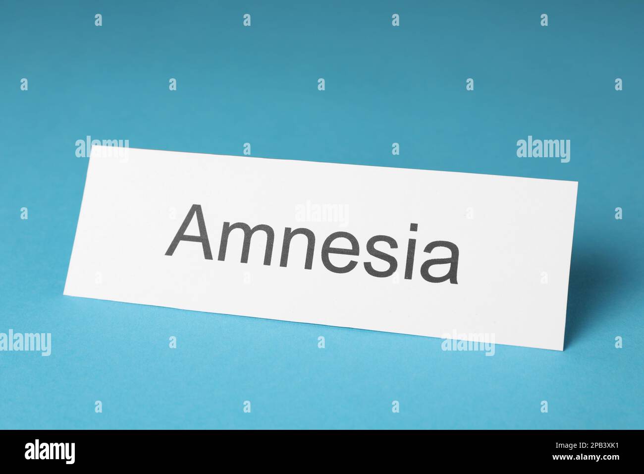 Card with word Amnesia on light blue background Stock Photo - Alamy