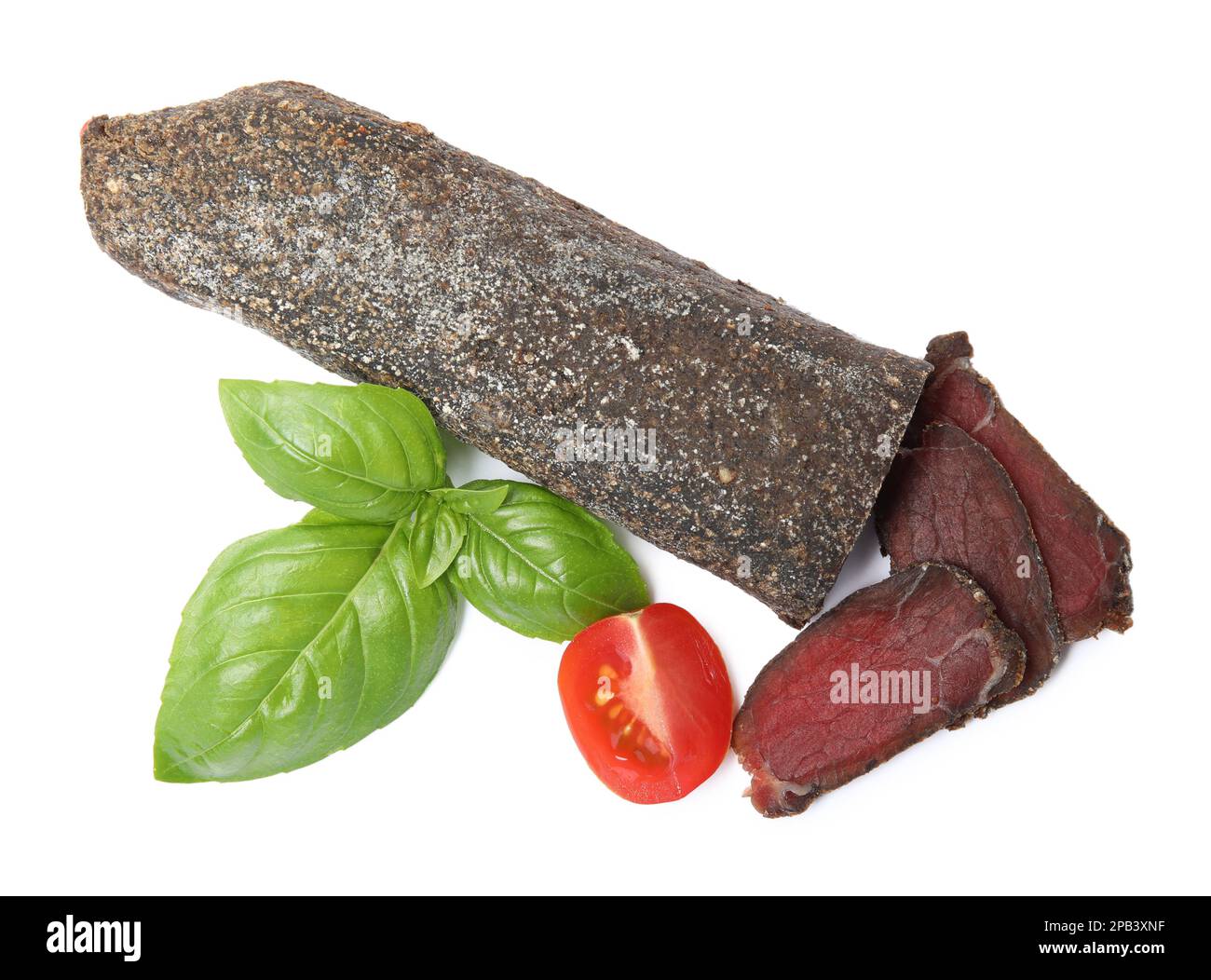 Delicious dry-cured beef basturma with basil and tomato on white ...