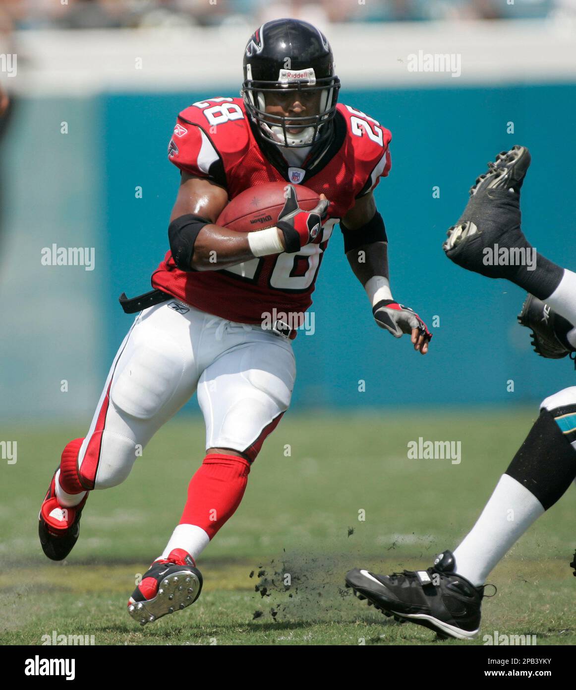 Atlanta Falcons running back Warrick Dunn runs past an upended ...