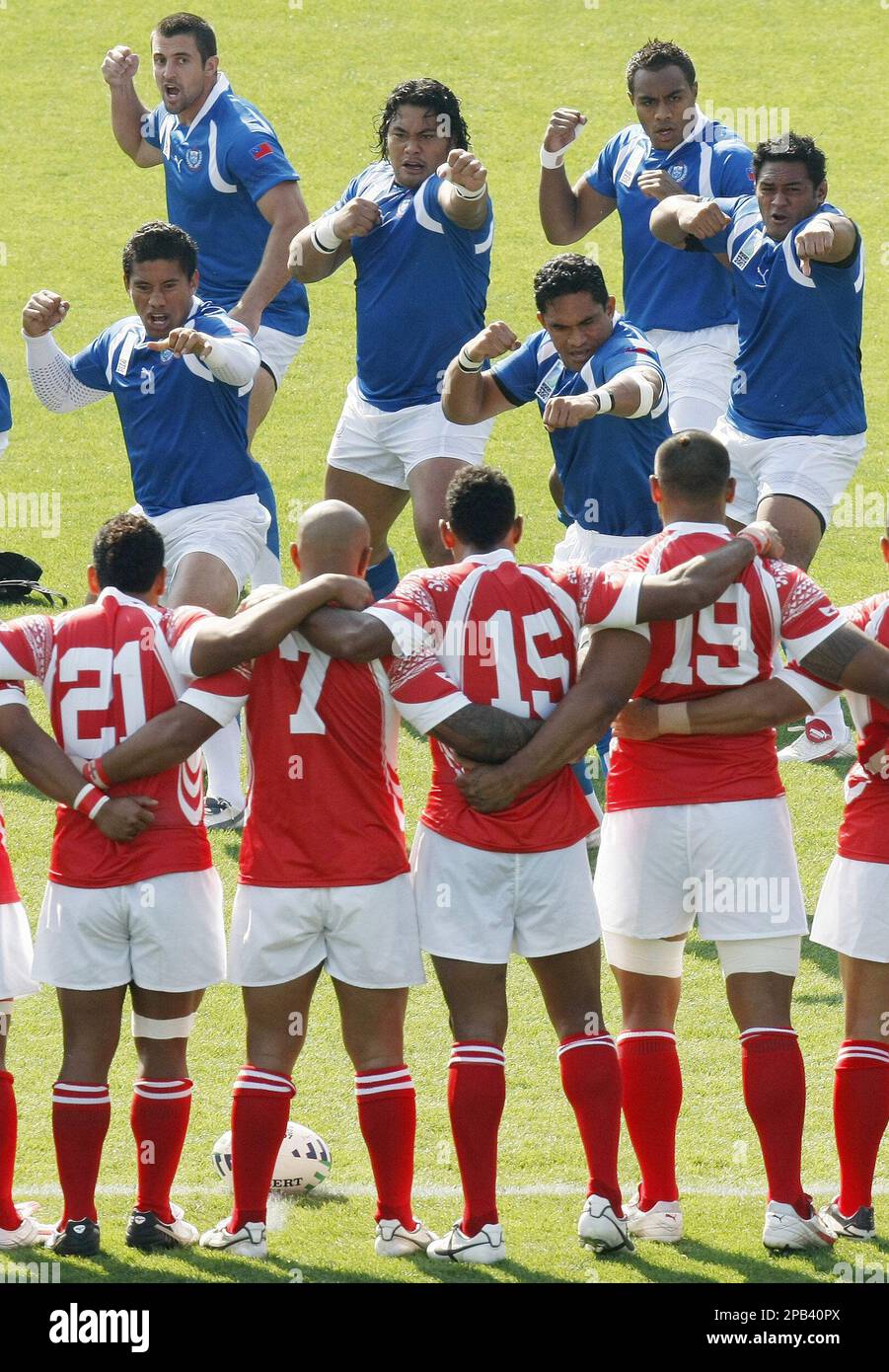 Members of the Samoan team perform their "Haka" chant against Tonga ...