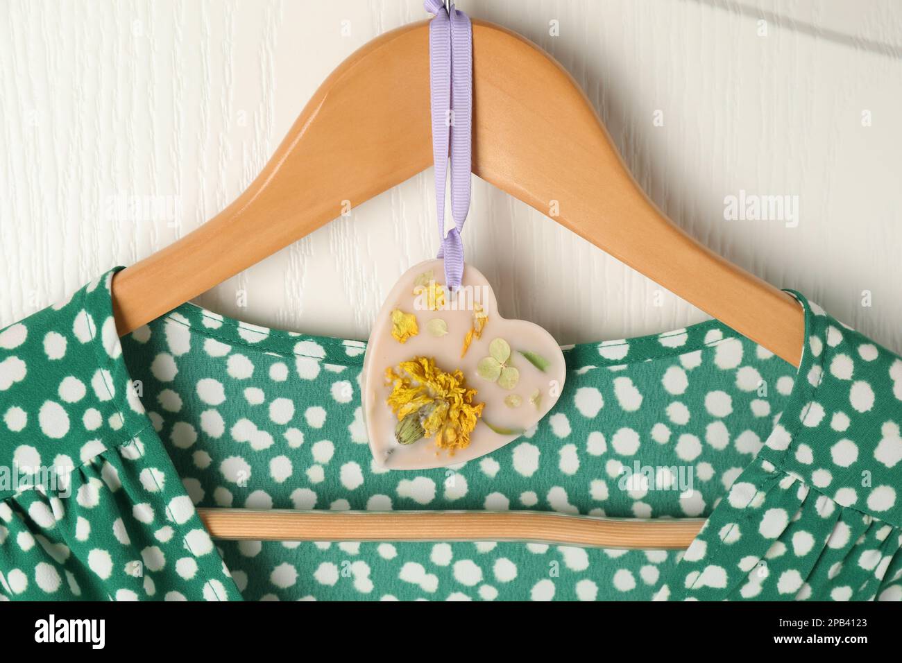 Scented sachet with flowers and stylish clothes on hanger Stock Photo ...