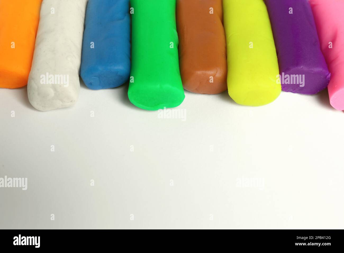Different color play dough on white background, closeup Stock Photo - Alamy