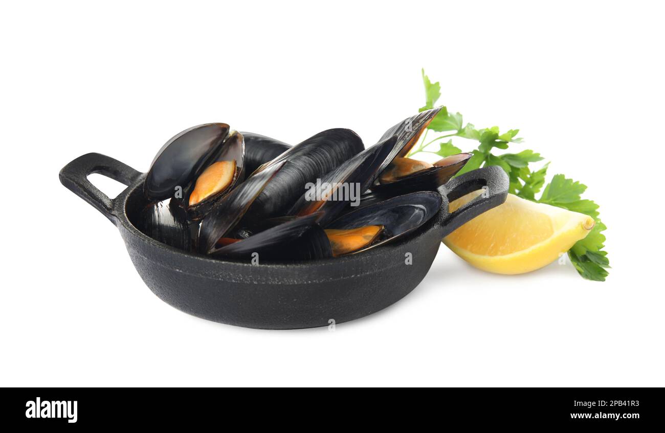 Pan of cooked mussels with parsley and lemon on white background Stock ...