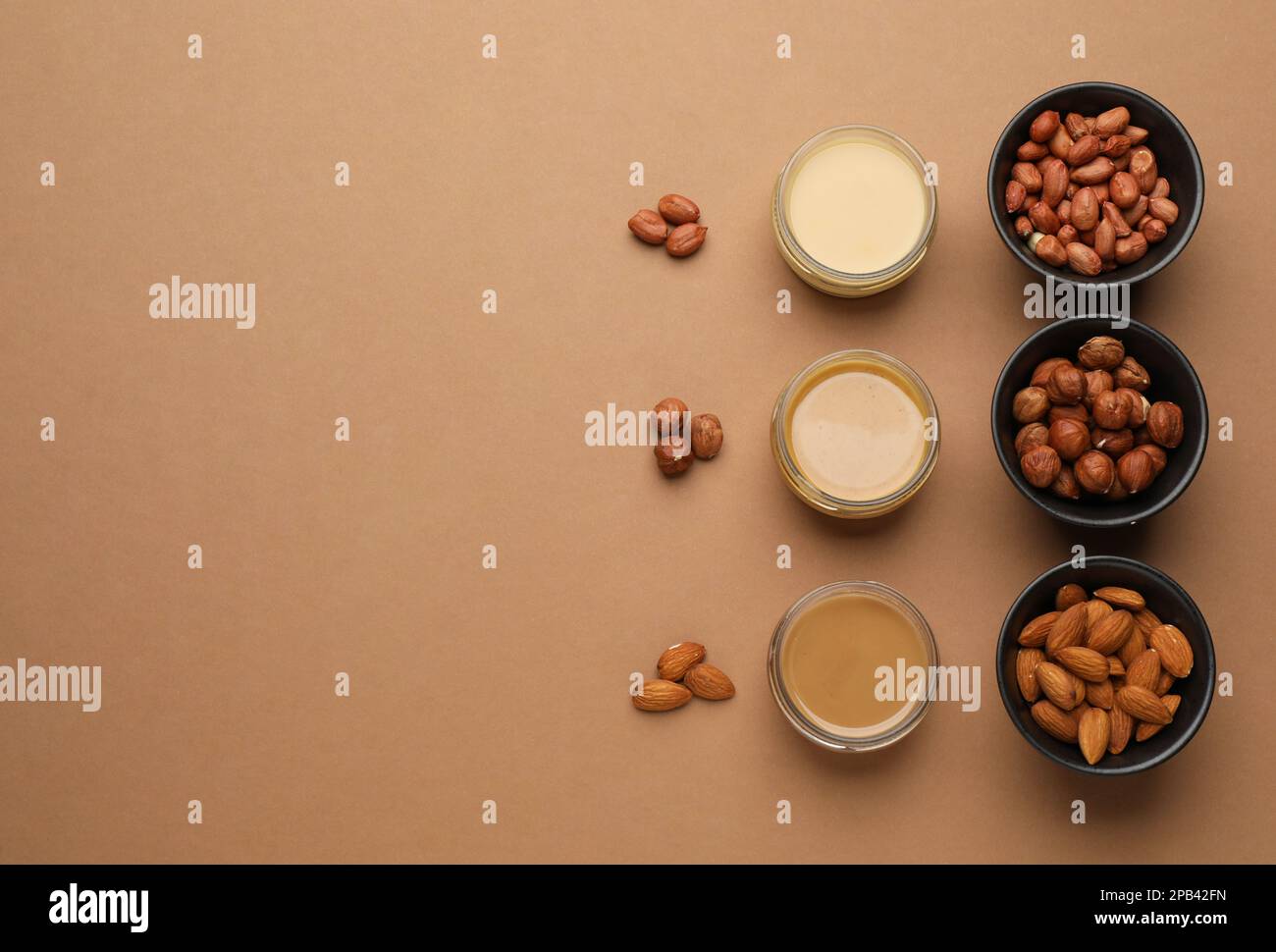 Different types of delicious nut butters and ingredients on brown ...