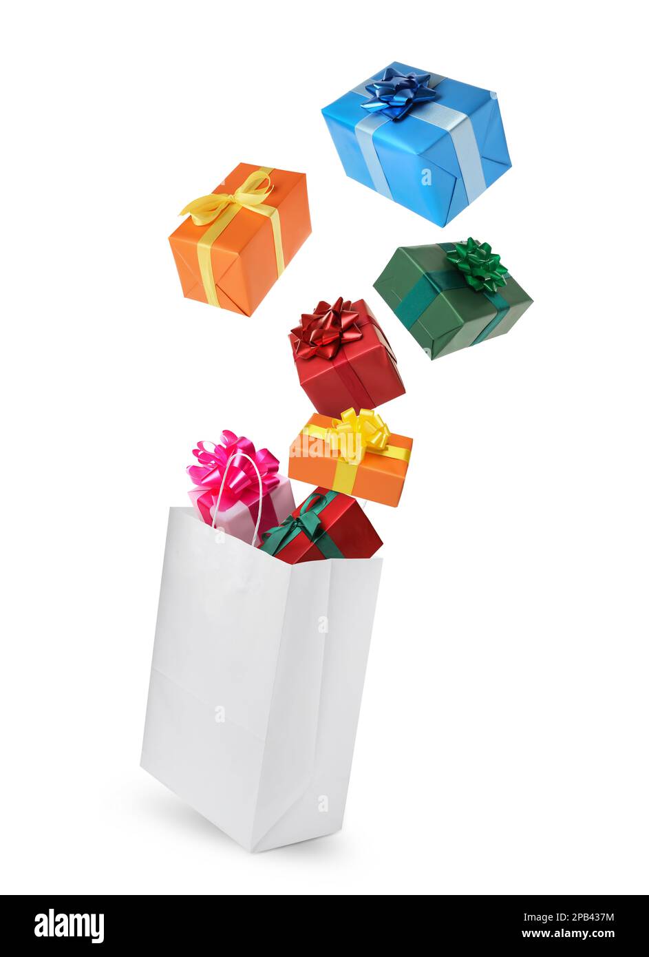 Many different gift boxes falling into paper shopping bag on white ...