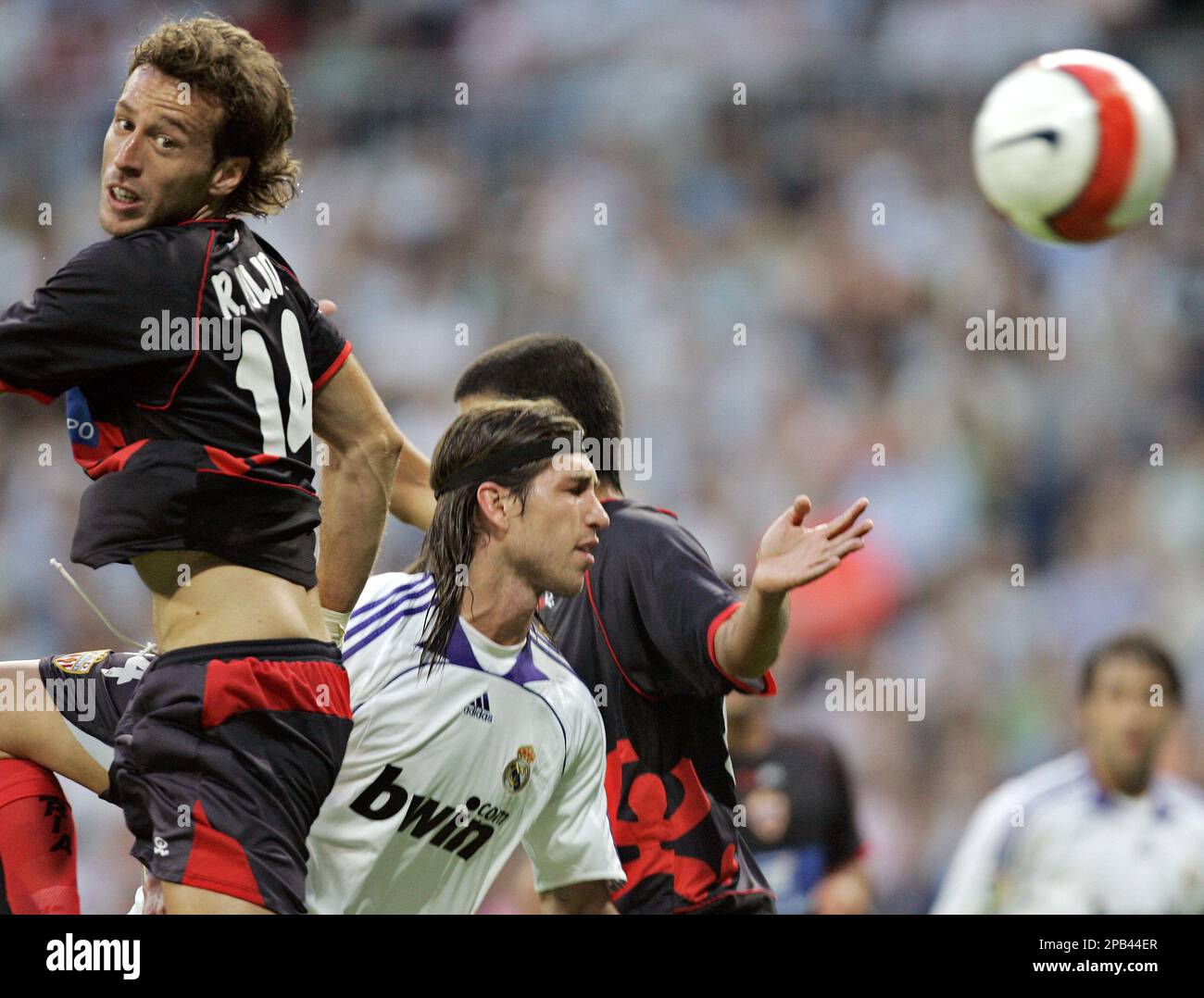 Almeria's Ruben Martin Pulido , left, heads the ball away from Real ...