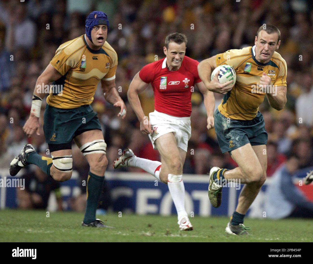 Australia's Chris Latham, right, runs on his way to scoring a try ...