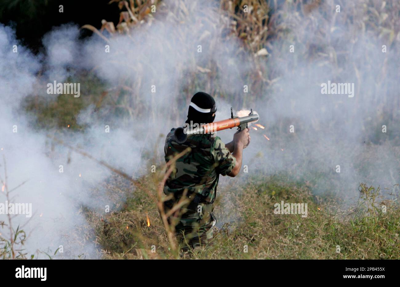 A militant from violent group the Popular Resistance Committees shoots ...