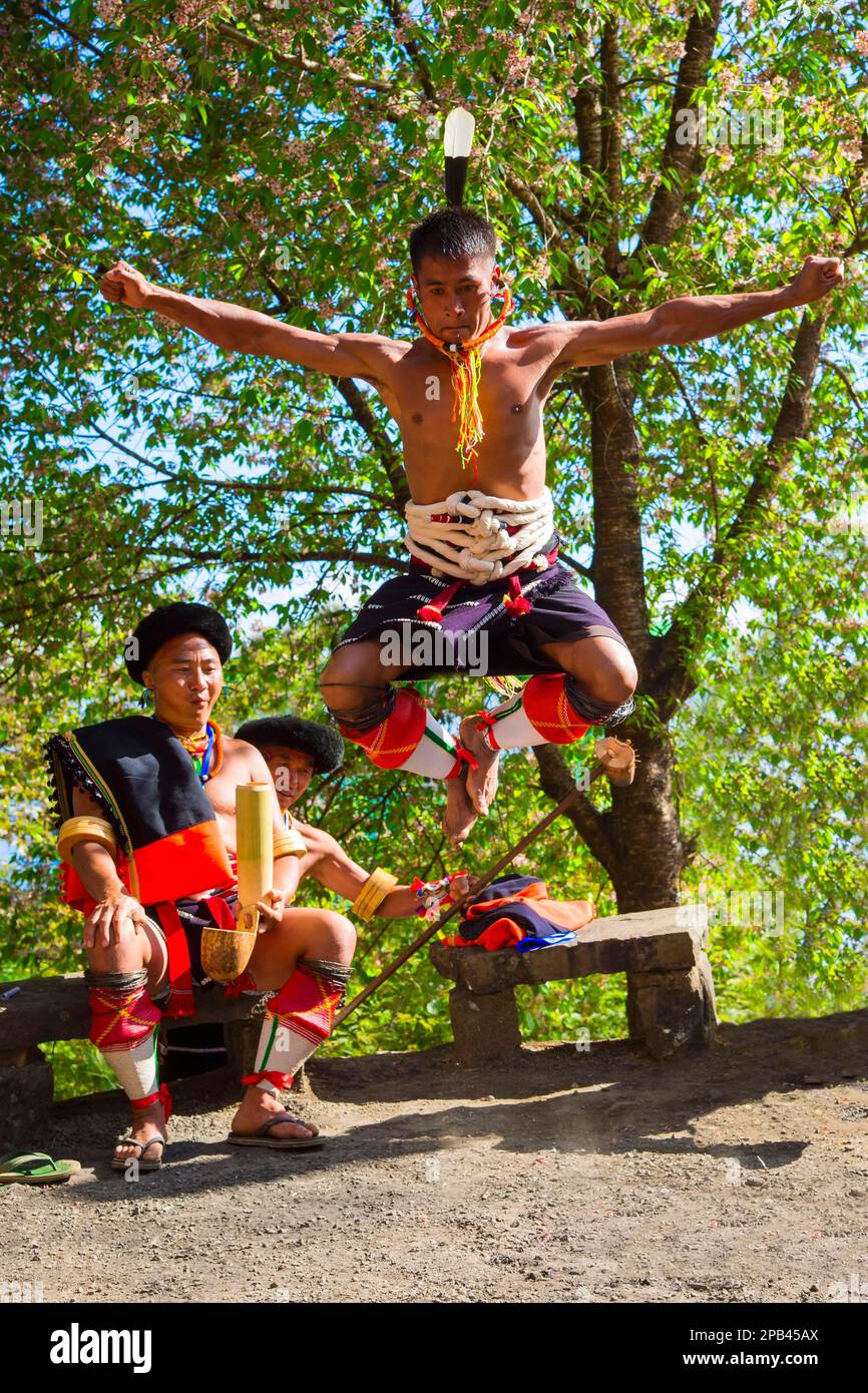 Naga tribesman in traditional dress performing a warrior dance, Kisima ...