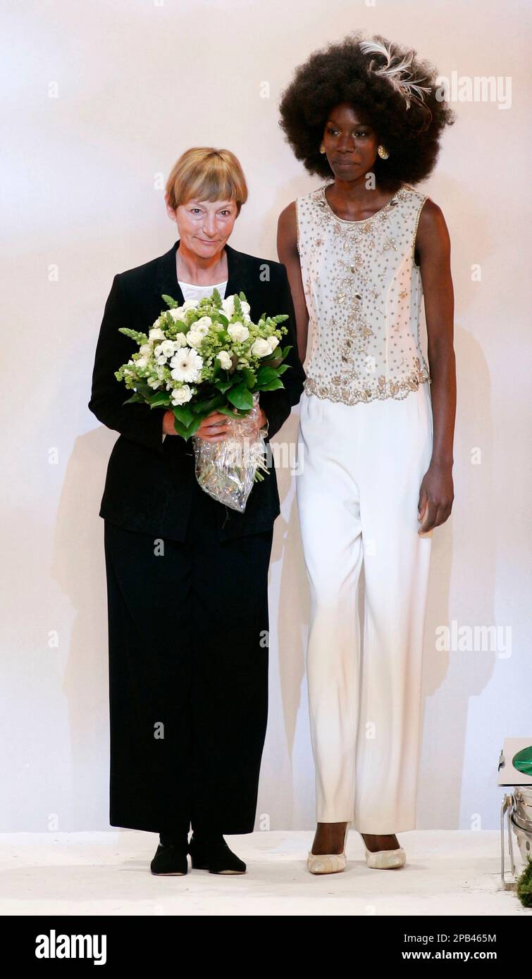 Designer Caroline Charles, left, poses with a model wearing one of her ...