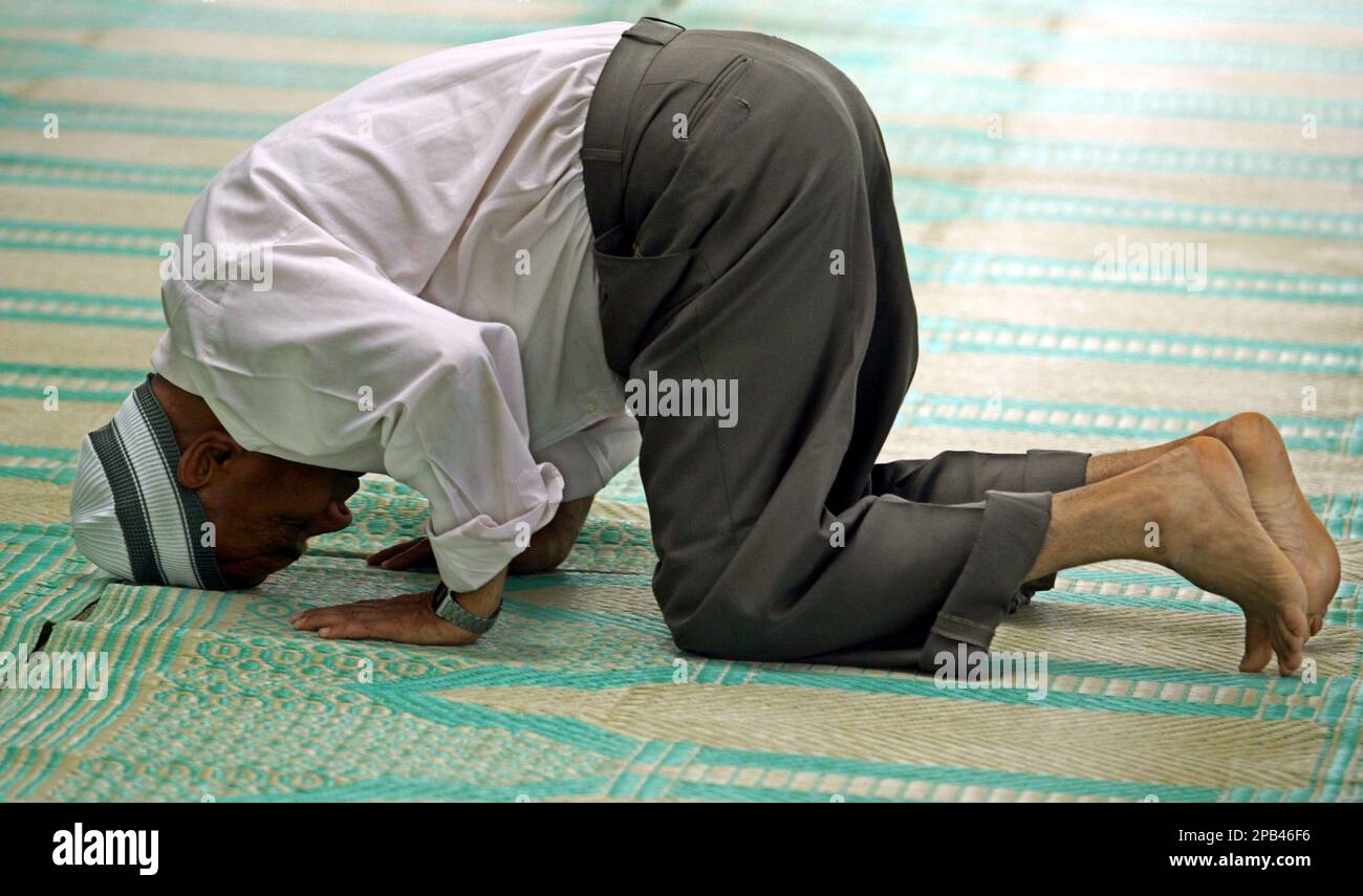 A Kenyan Muslim bows down in prayers, at Masjid Noor mosque in Nairobi ...