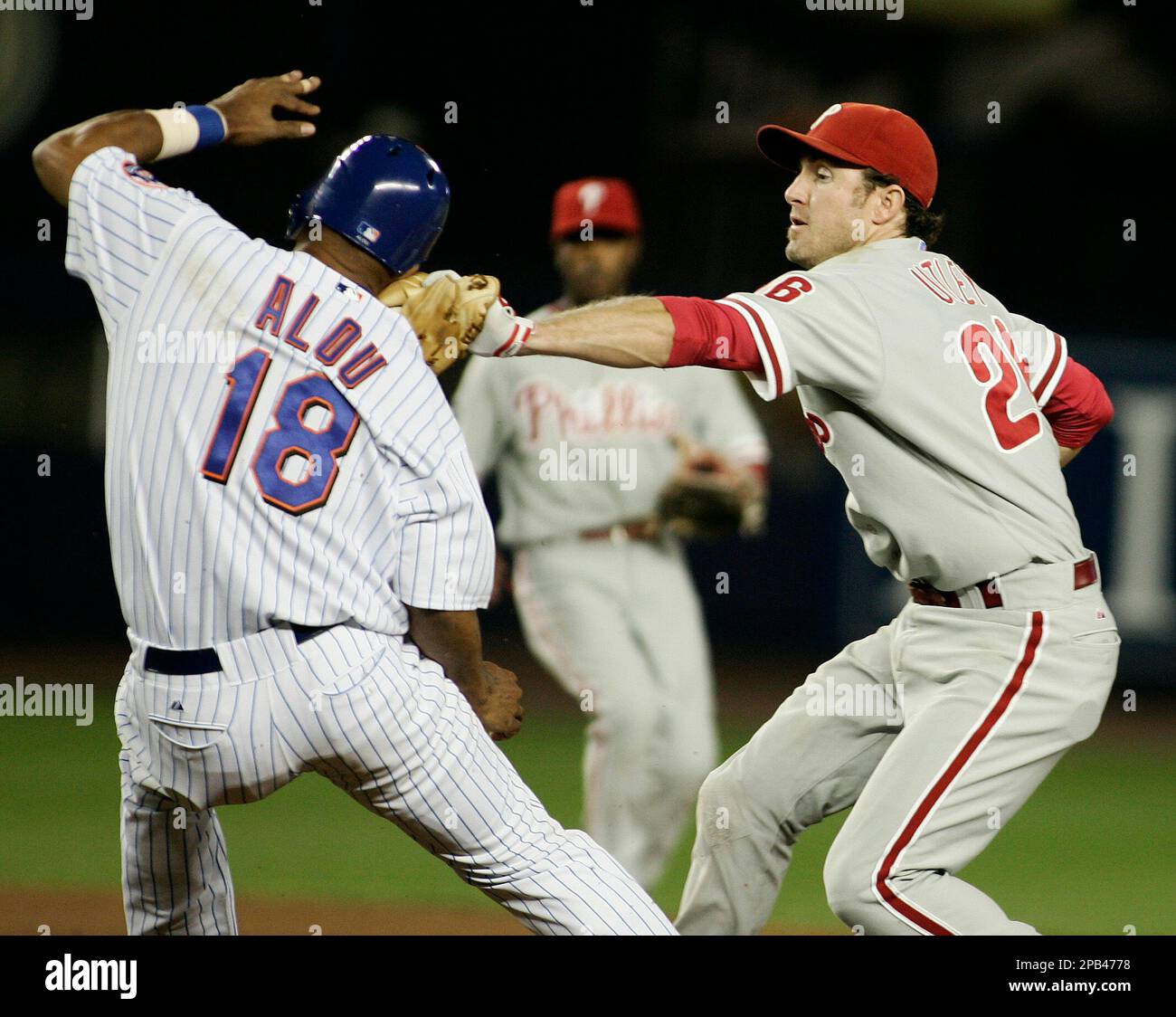 New York Mets' Moises Alou (18) is tagged out by Philadelphia Phillies ...