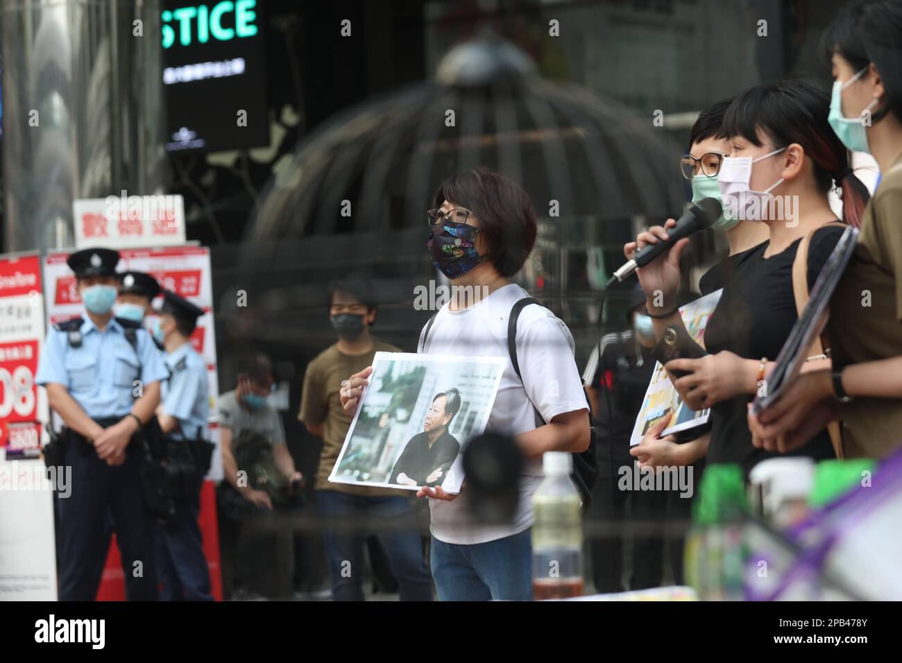 Lee Cheuk-yanHH wife Elizabeth Tang holds his picture while meeting the ...