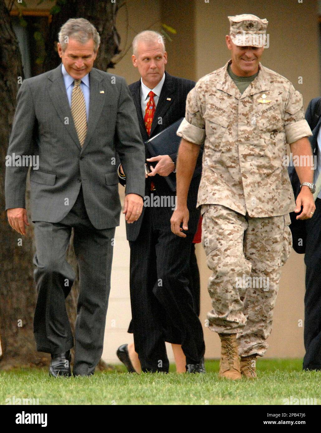 President Bush walks with U.S. Marine Corps Col. George Smith Jr ...