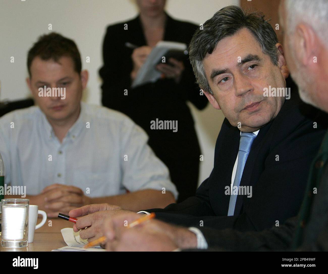 Britain's Prime Minister Gordon Brown, second right, listens to Mike ...