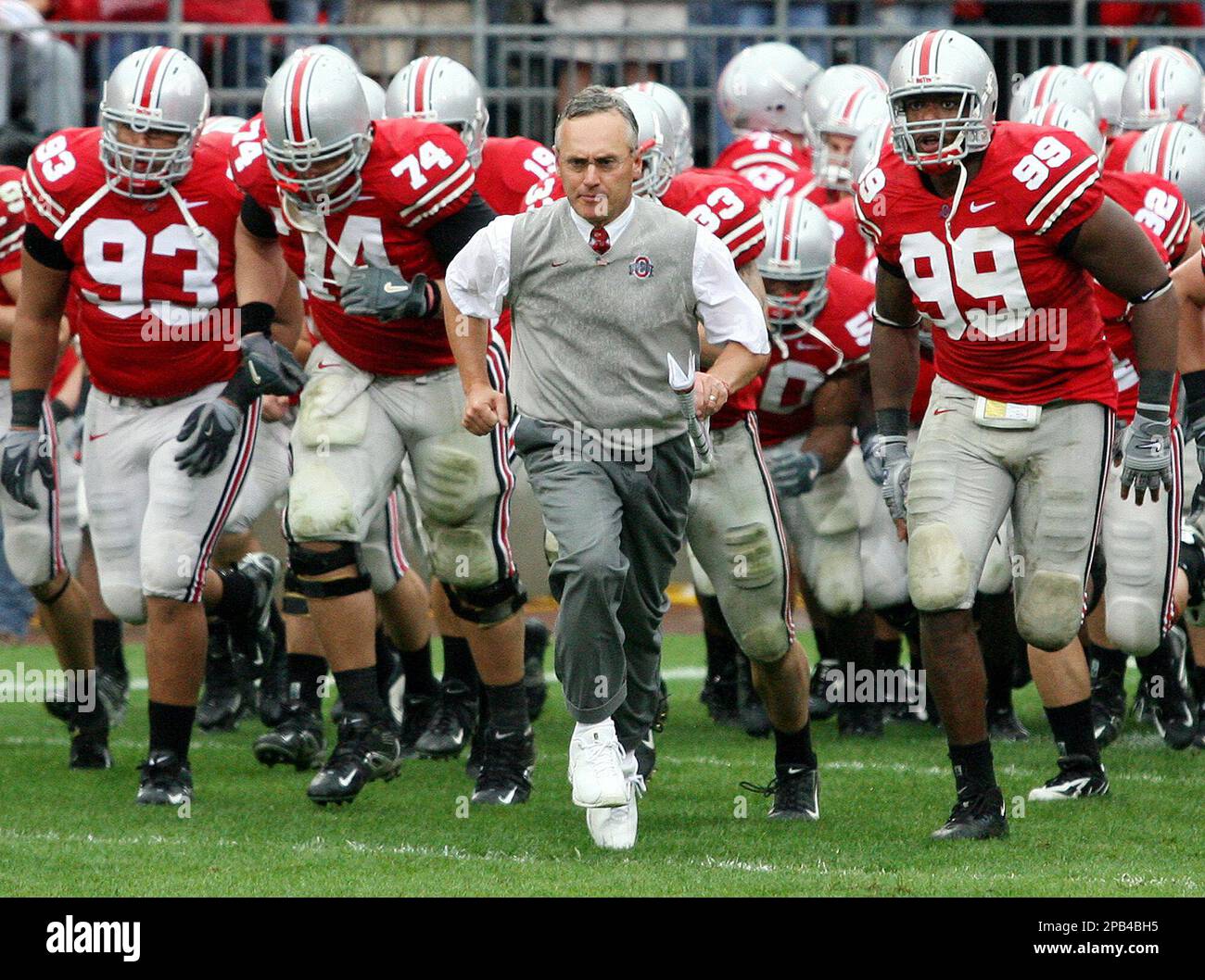 ** FILE ** Ohio State football coach Jim Tressel, center, leads his ...