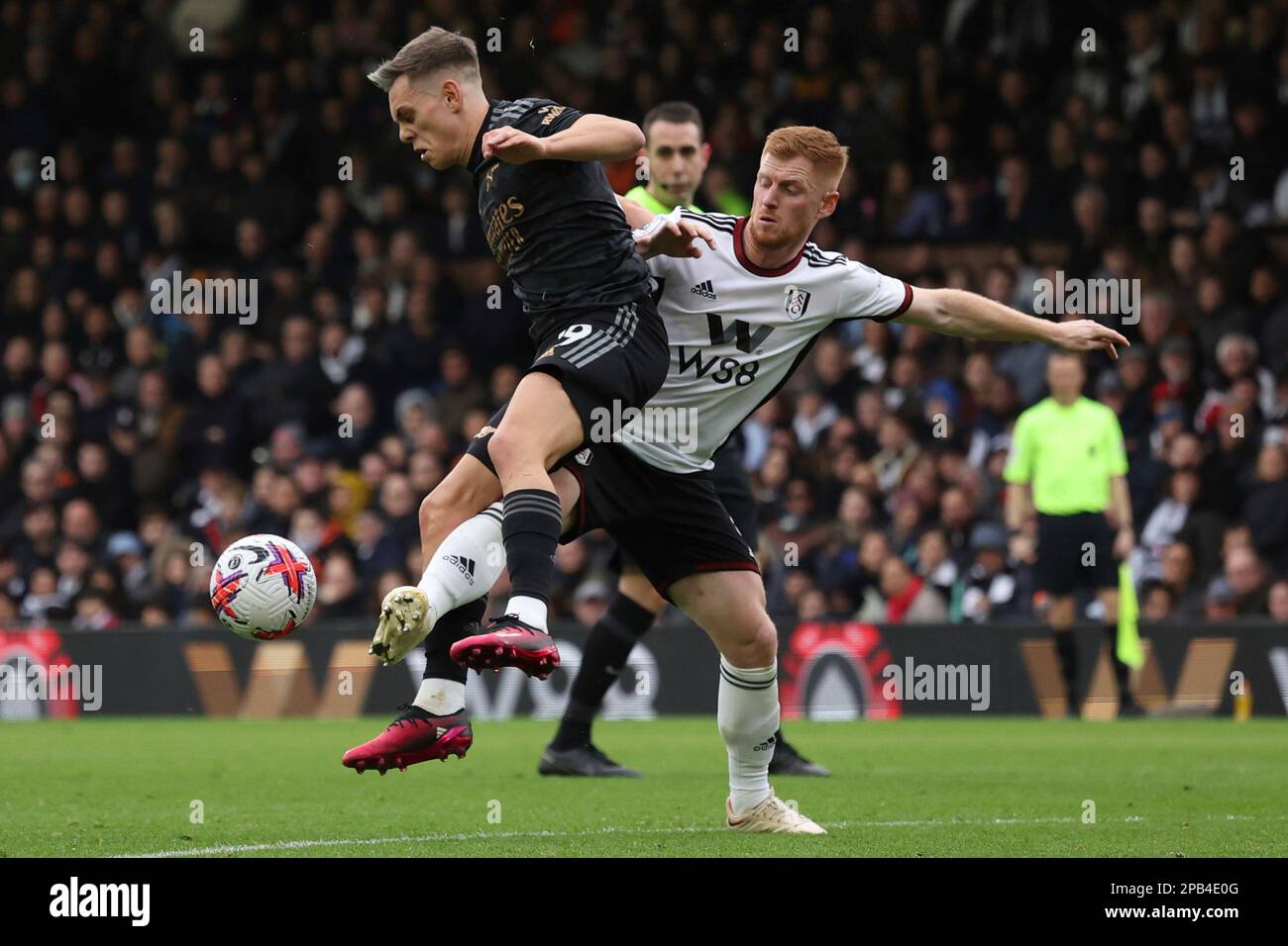 Arsenal's Leandro Trossard, left, duels for the ball with Fulham's ...