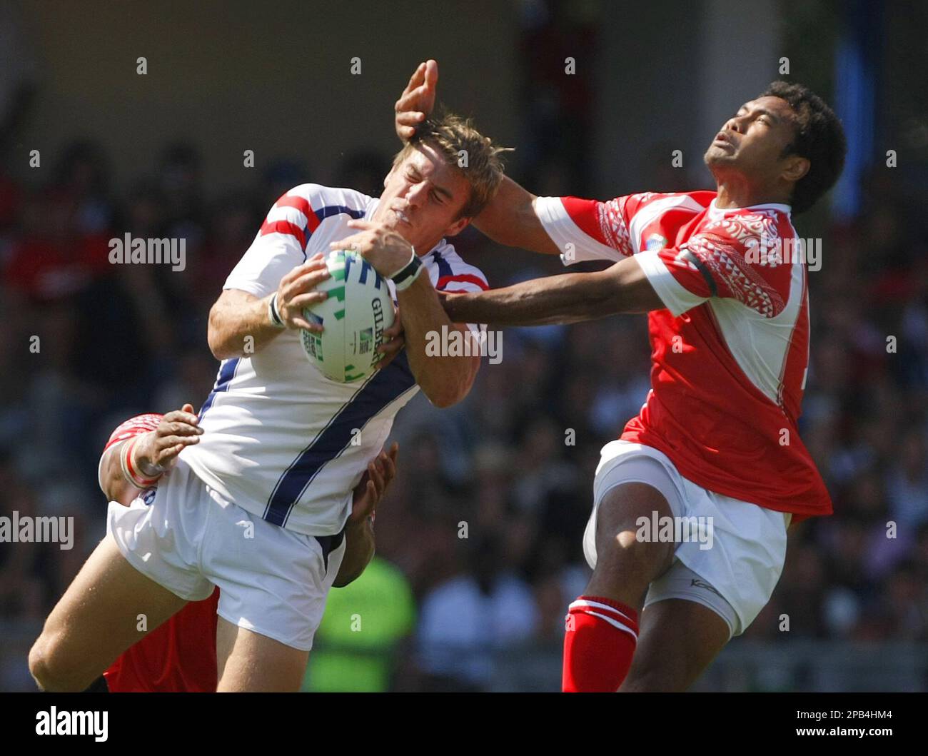 Chris Wyles of the U.S., left, is grabbed in midair by Tonga's Epeli ...