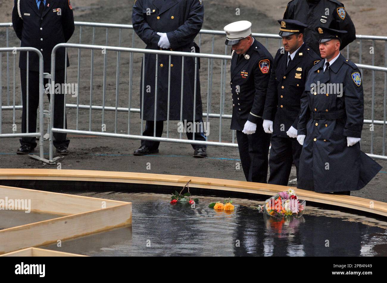 Friends and relatives are seen during a ceremony to mark the sixth ...