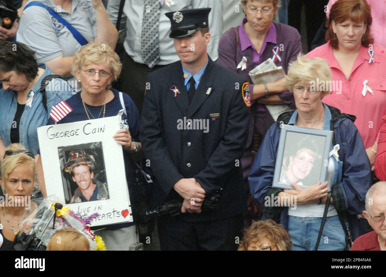 A New York City fireman is flanked by mourners during ceremonies ...