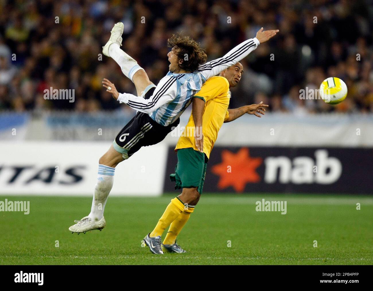 Argentina's Gabriel Heinze, left, and Australia's Archie Thompson ...