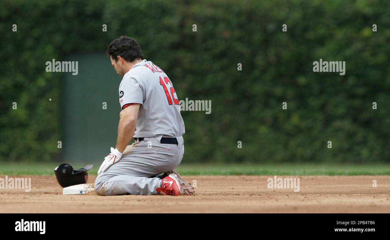 St. Louis Cardinals' Aaron Miles kneels at second base after being ...