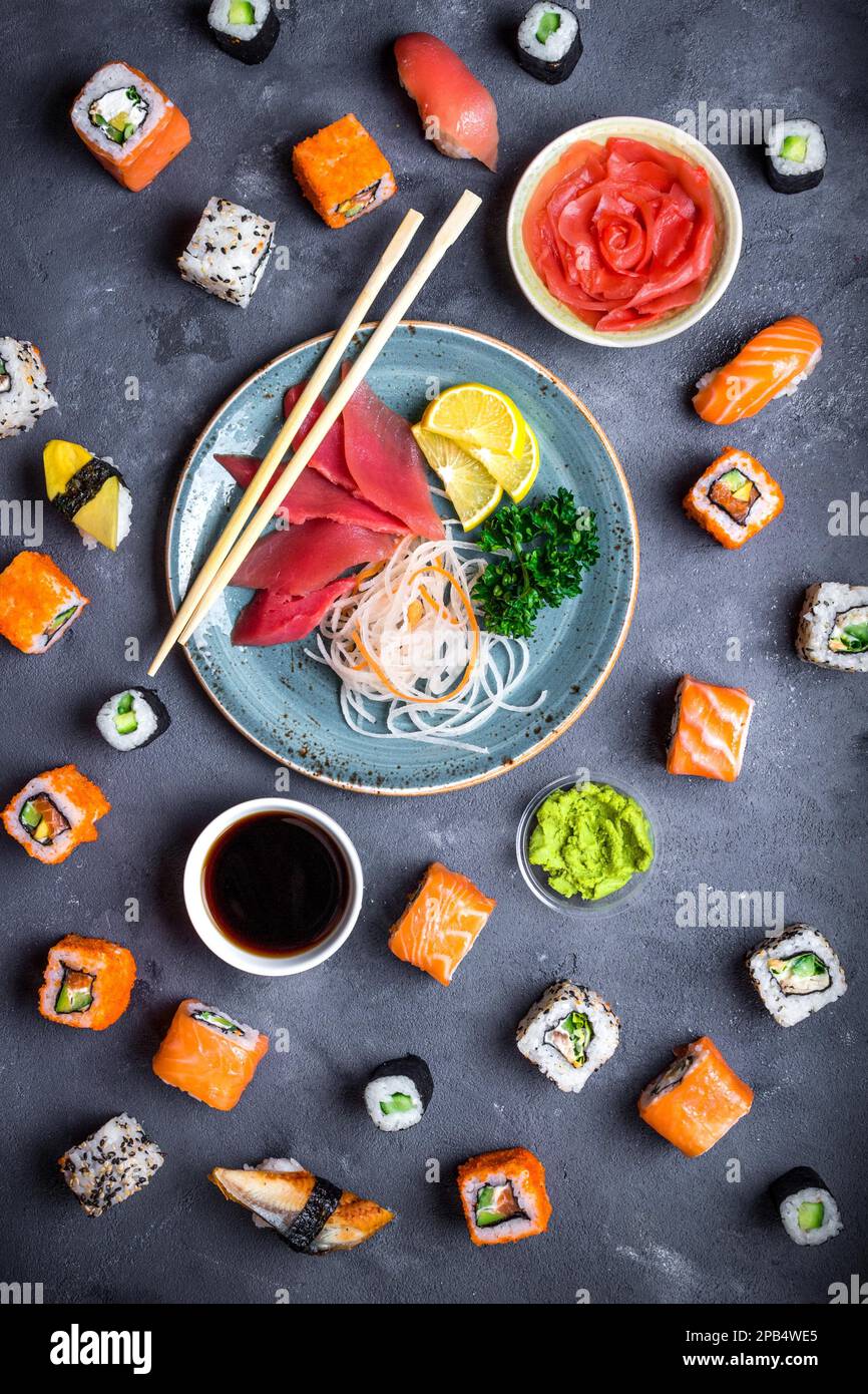 Japanese sushi on a rustic dark background. Sushi rolls, sashimi ...