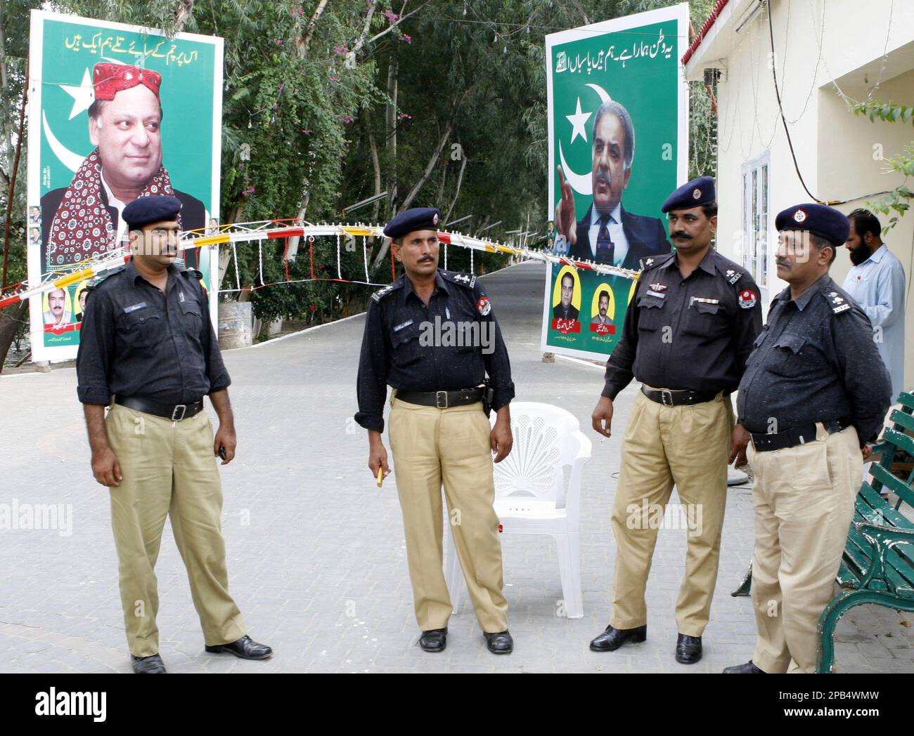 Pakistani police officers stand outside the residence of Pakistan's ...