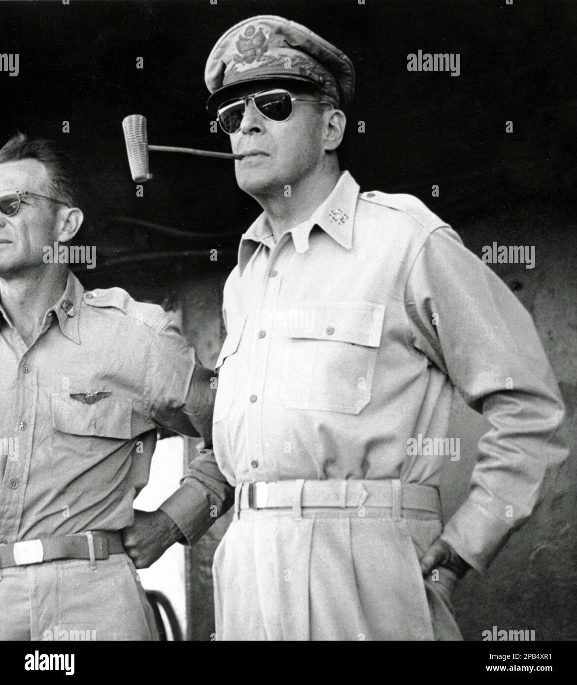 ** FILE ** Five star Gen. Douglas MacArthur smokes one of his trademark ...