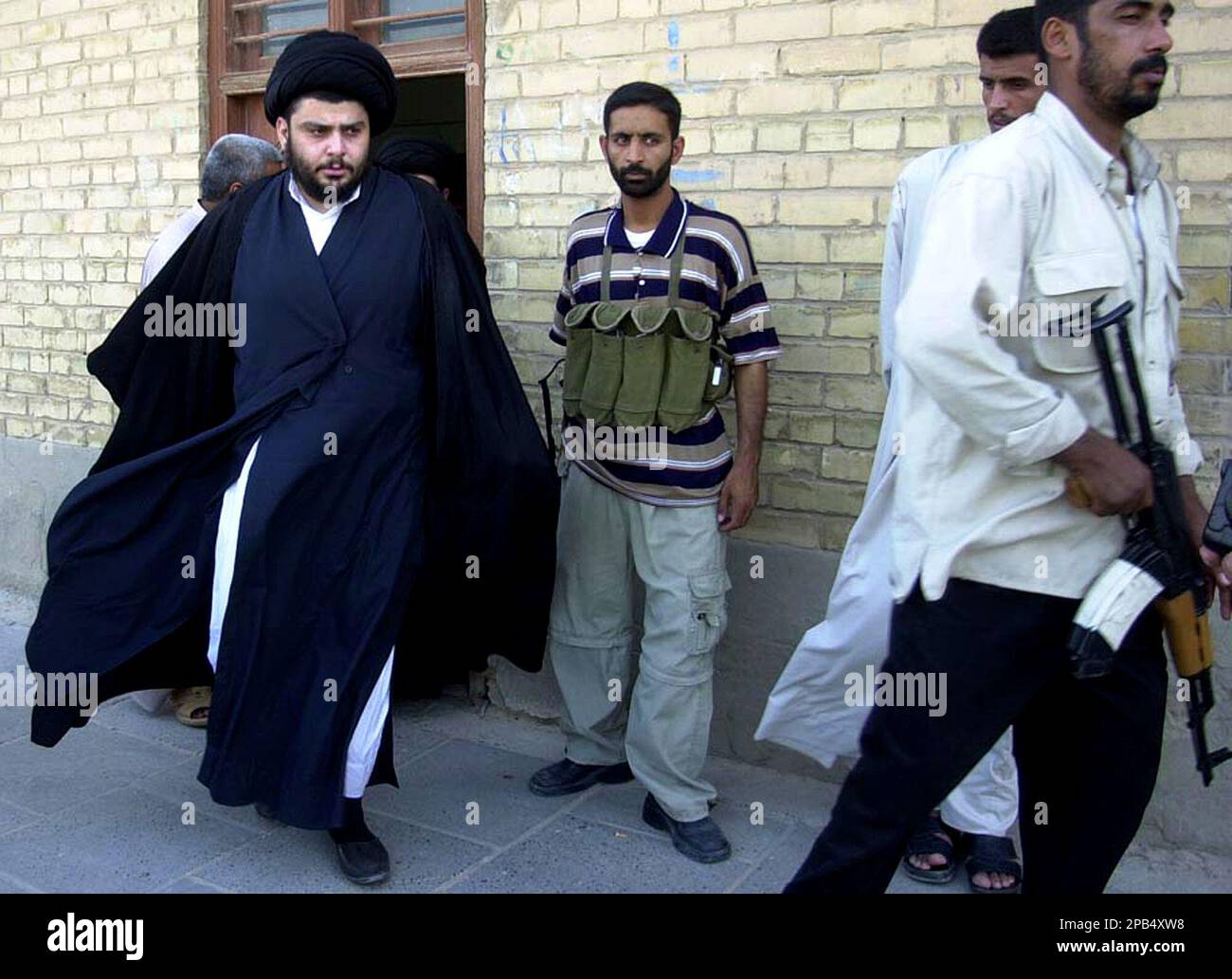 ** FILE ** Shiite cleric Muqtada al-Sadr, left, steps from an office ...