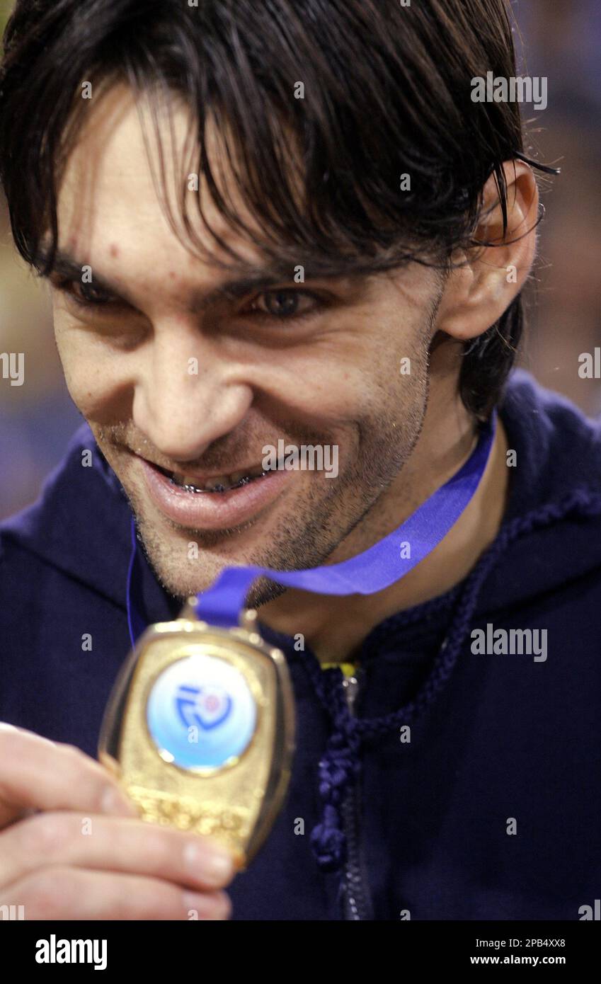 Brazil's Giba shows his championship medal after Brazil defeated ...
