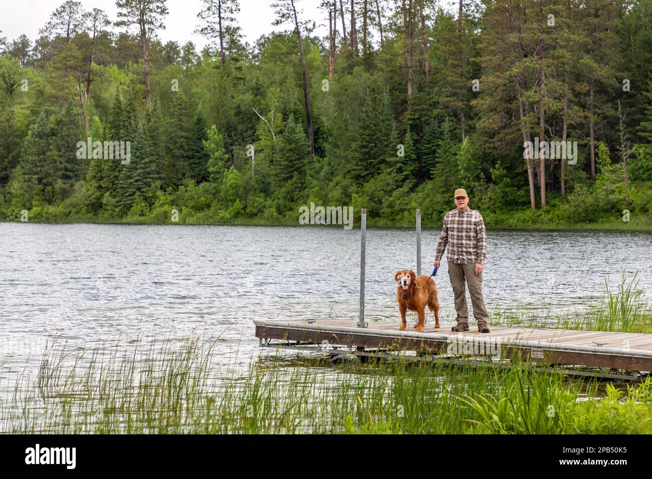 Man with dog on dock hi-res stock photography and images - Alamy