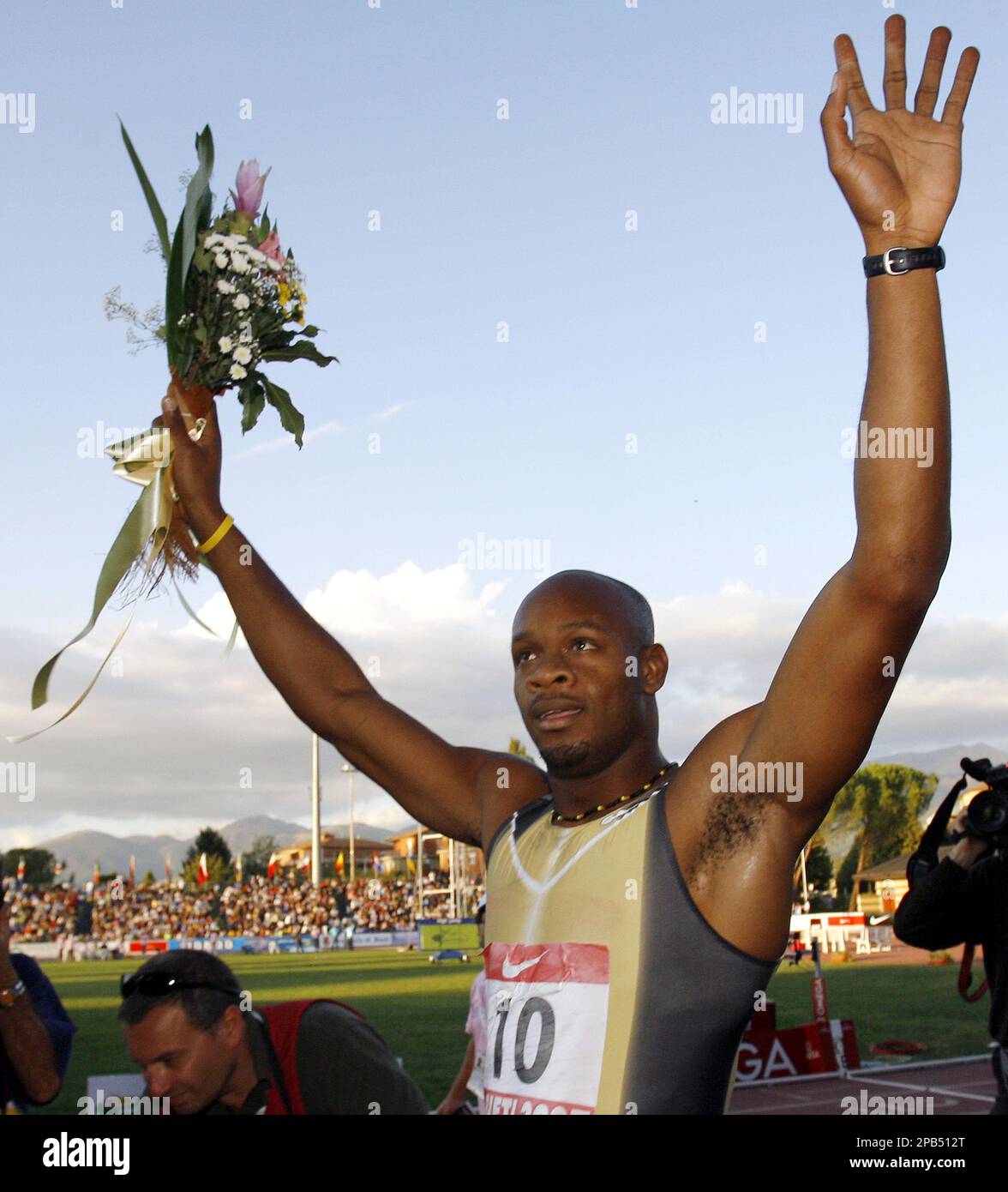 Asafa Powell of Jamaica acknowledges cheers from fans after winning the ...