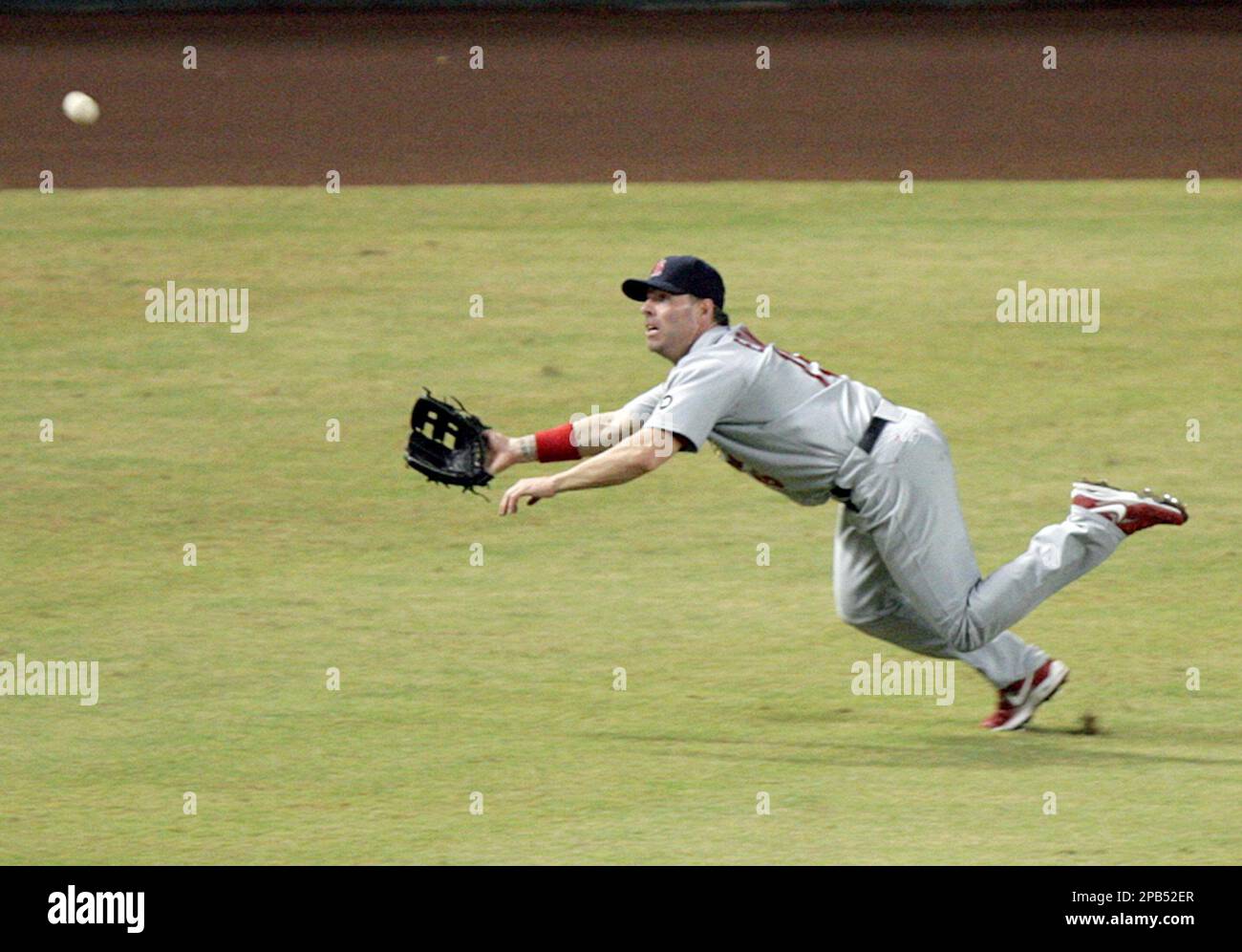 St. Louis Cardinals center fielder Jim Edmonds sprints to make a diving ...