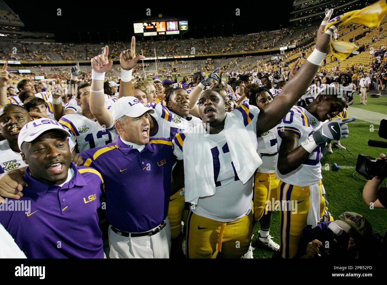 LSU coach Les Miles, center with fellow coach Larry Porter, left, and ...