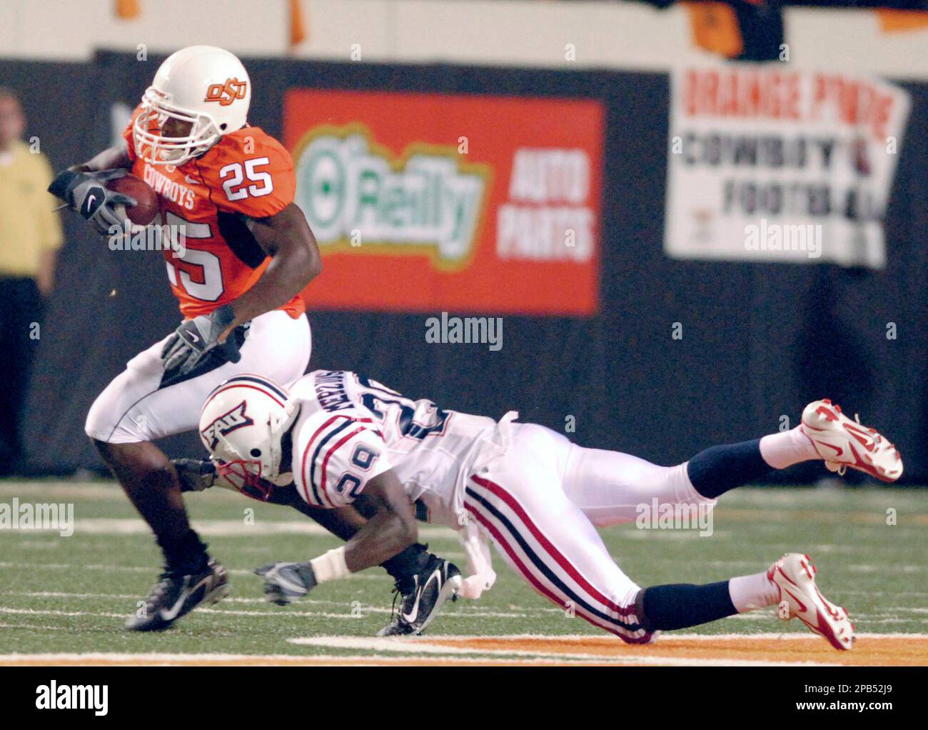 Oklahoma State running back, Chris Offor, left, tries to escape the ...