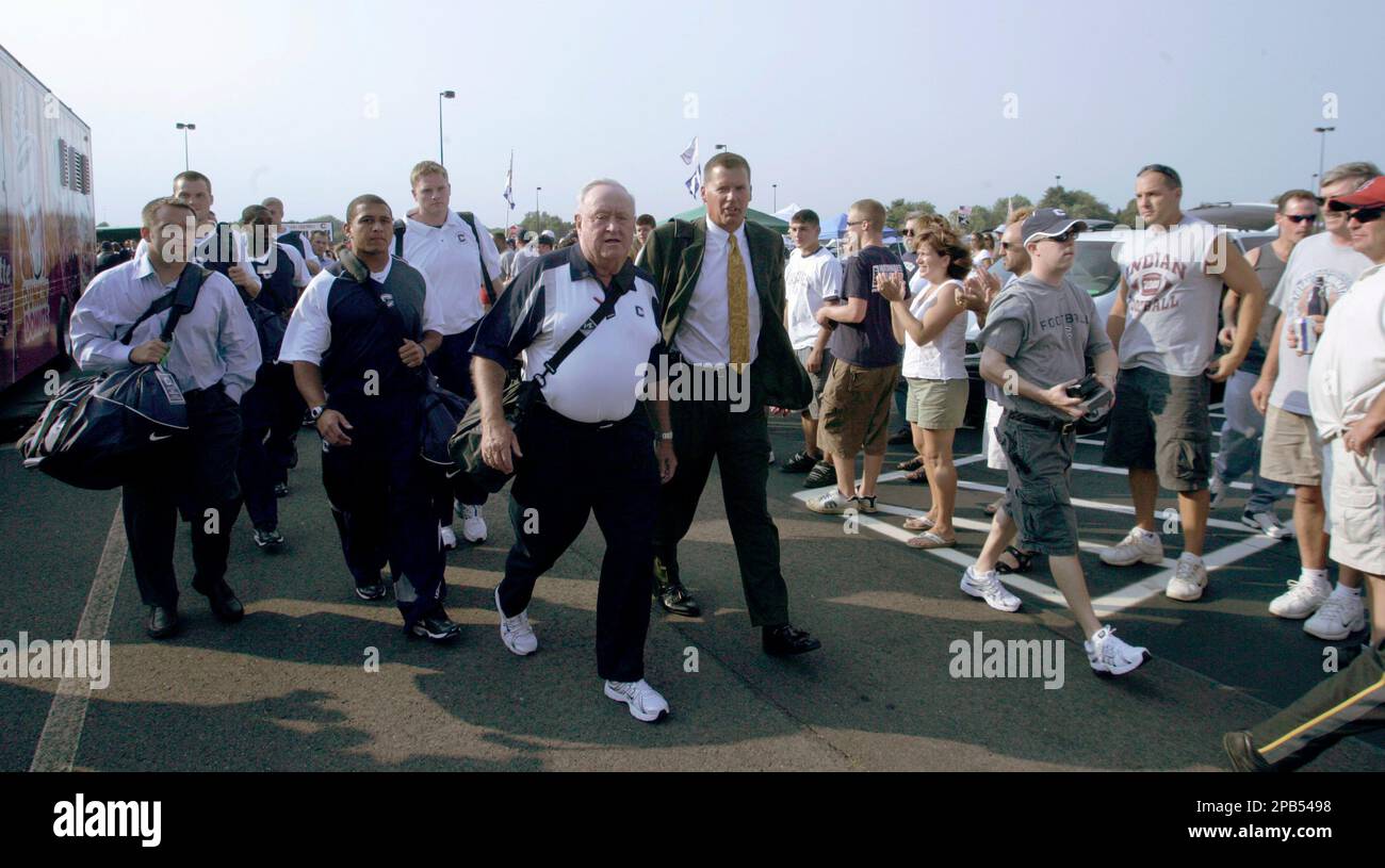 Connecticut football coach Randy Edsall, right in green suit and yellow ...