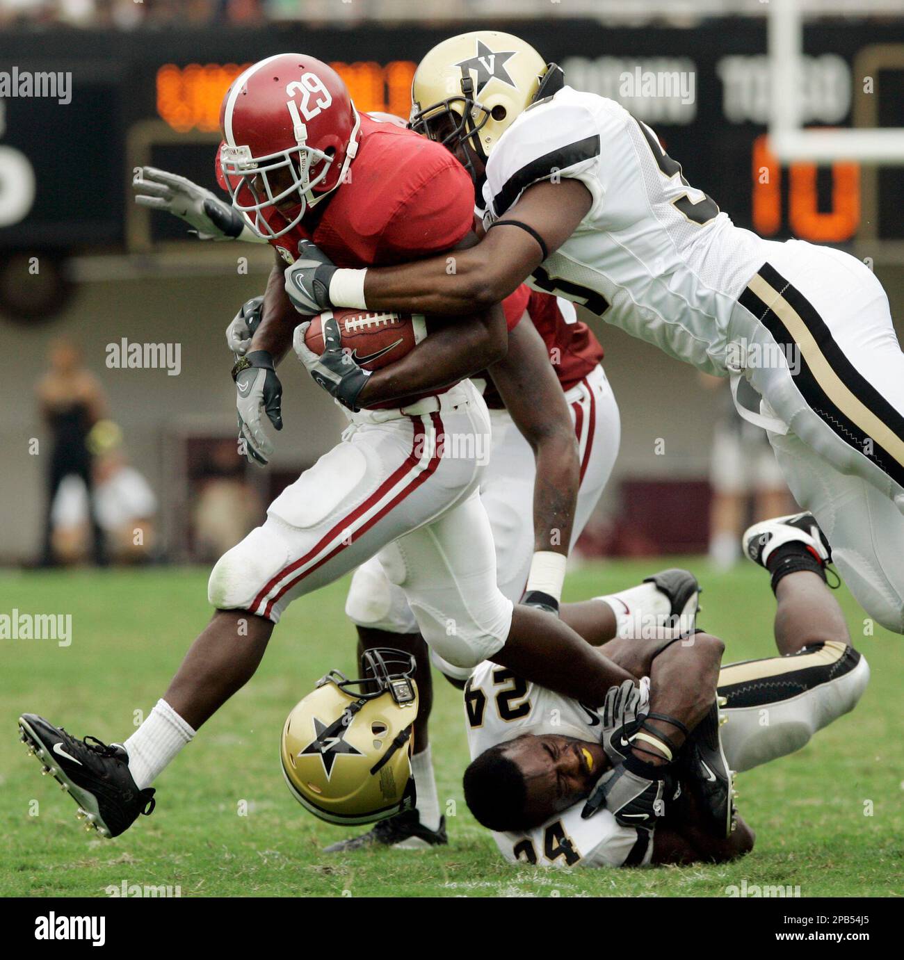 Vanderbilt linebacker Marcus Buggs (24) loses his helmet as he helps ...