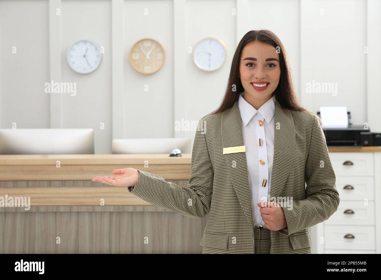 Portrait of beautiful receptionist near counter in hotel Stock Photo ...