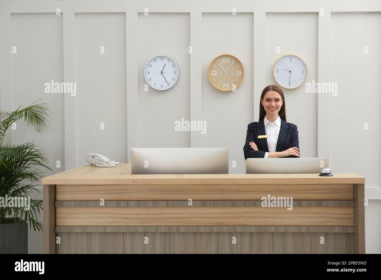 Portrait of beautiful receptionist at counter in hotel Stock Photo - Alamy