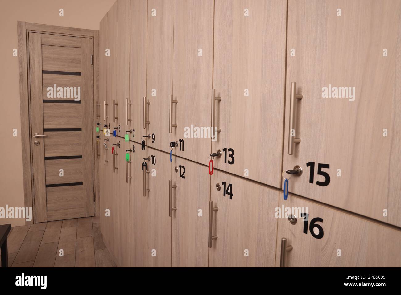 Many numbered wooden lockers with keys indoors Stock Photo - Alamy