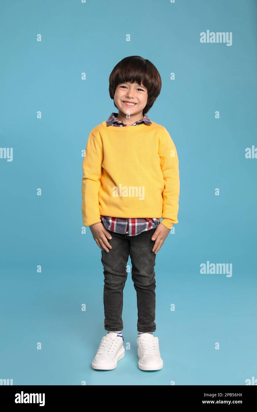 Full length portrait of cute little boy on light blue background Stock ...