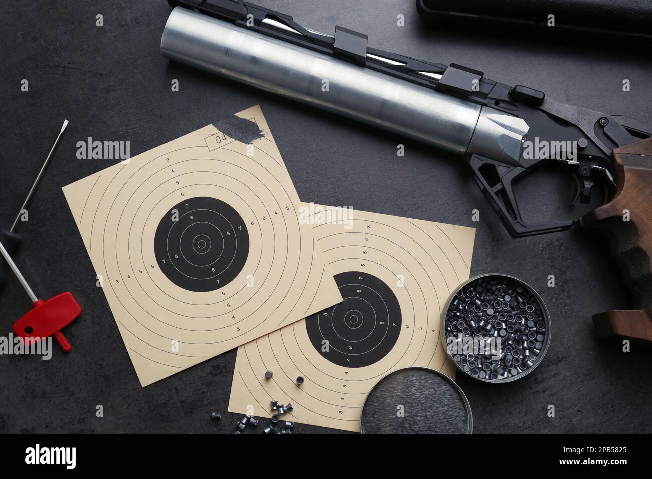 Flat lay composition with sport pistol on black table. Professional gun ...