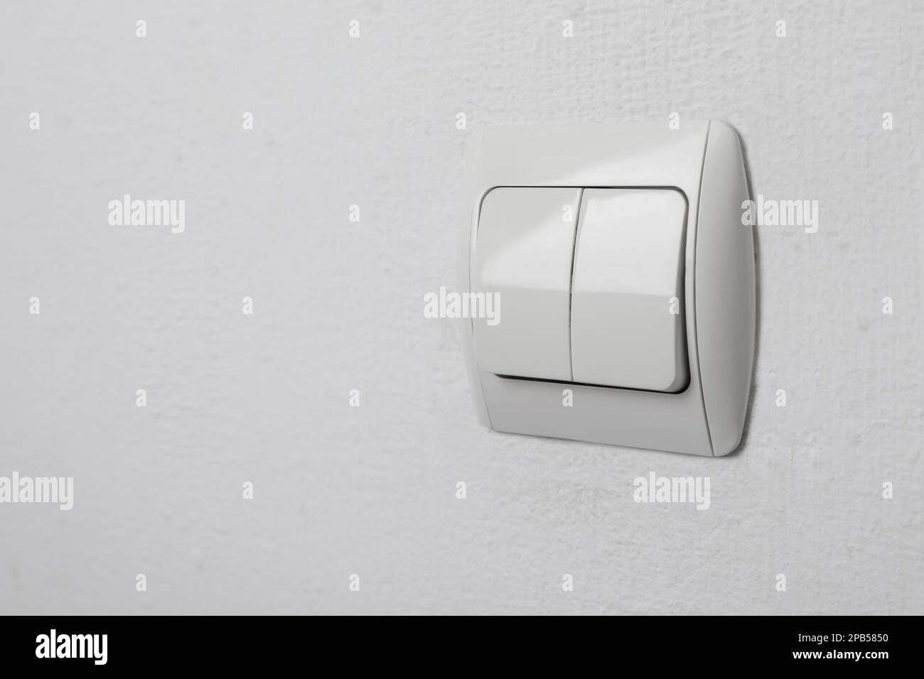 Modern light switch on white wall. Space for text Stock Photo - Alamy