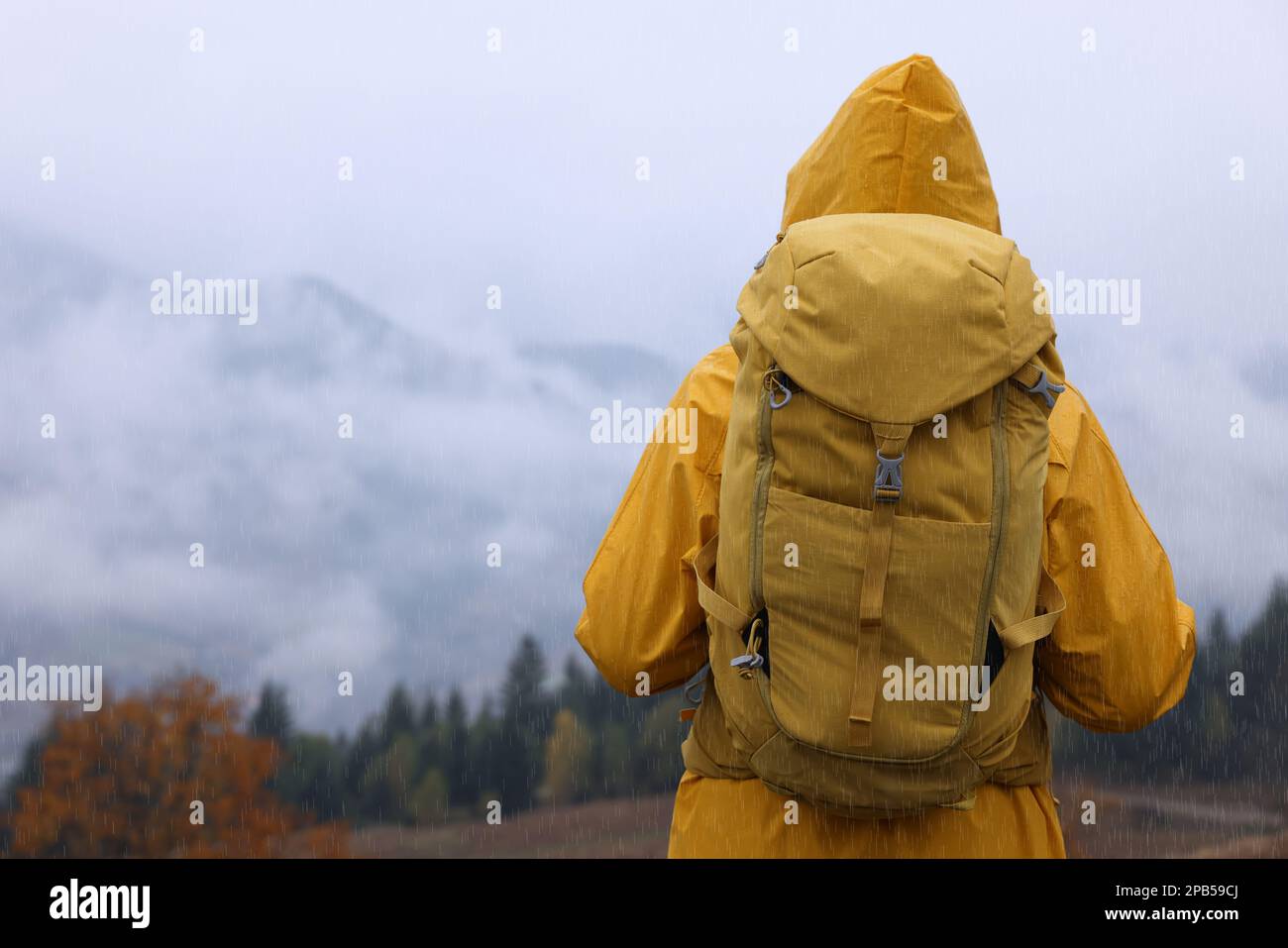 Woman backpack rain coat hi-res stock photography and images - Alamy