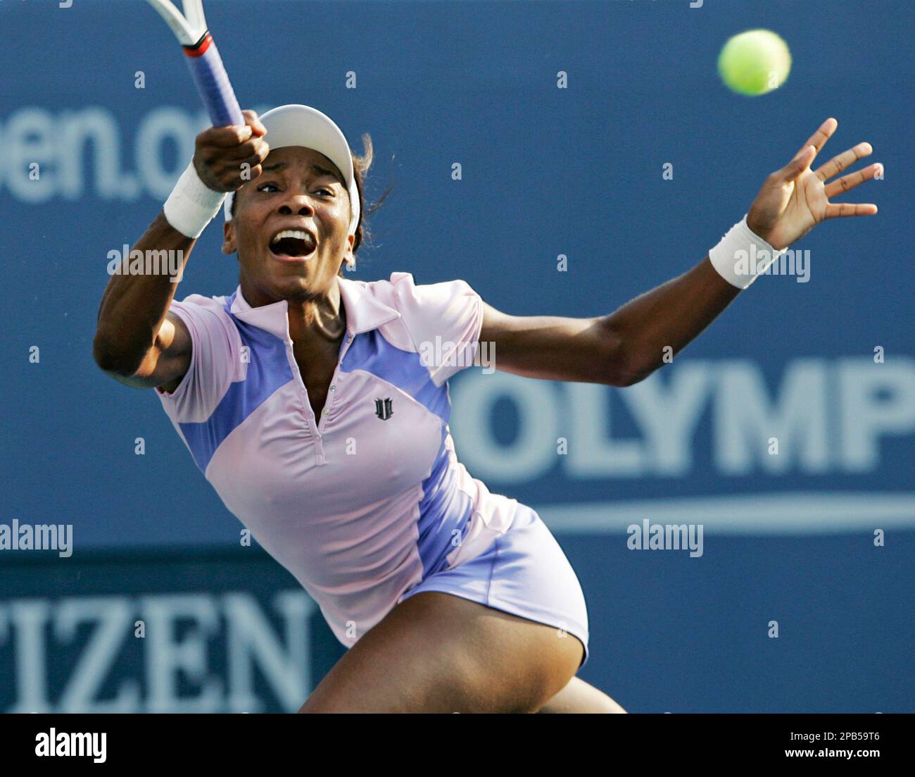 Venus Williams of the United States returns a volley to Justine Henin ...