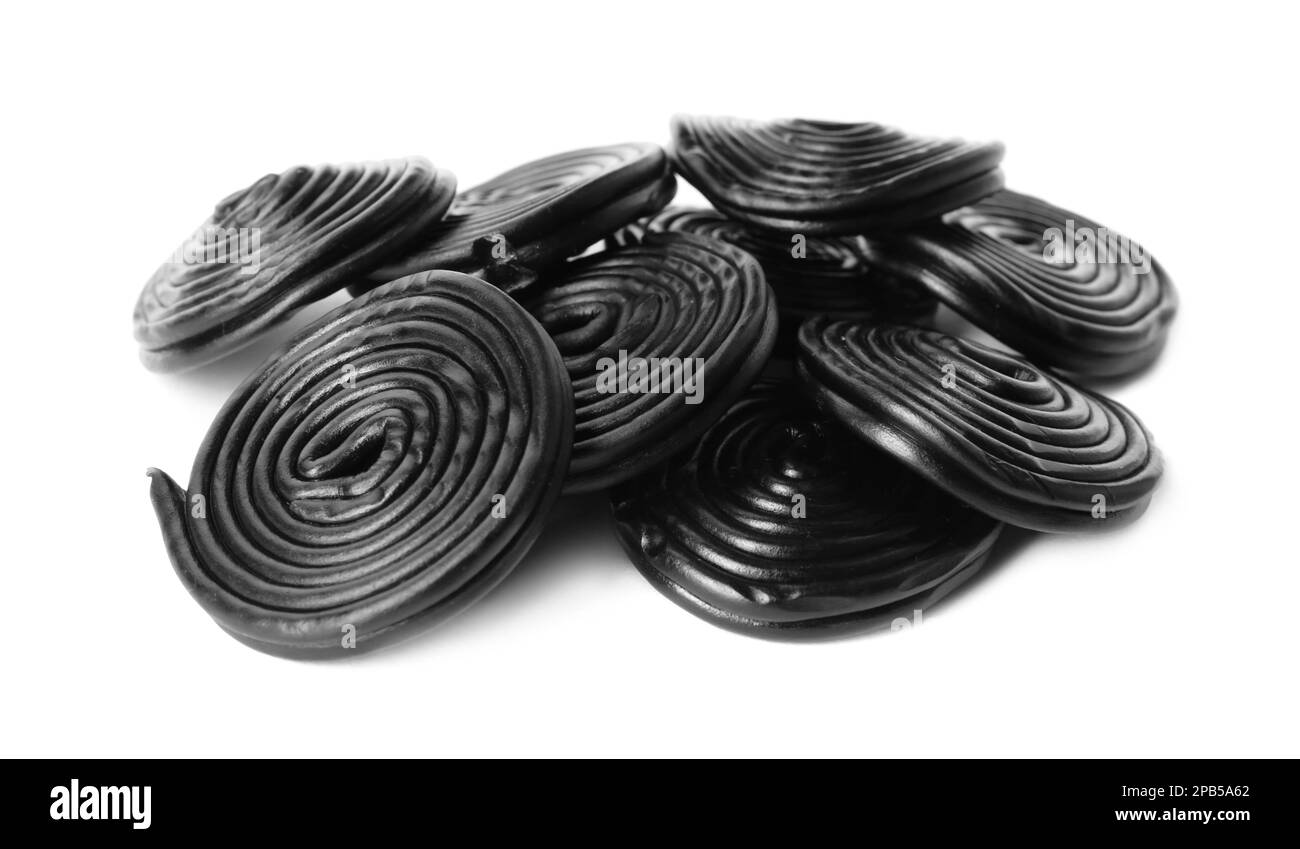 Tasty black liquorice candies on white background Stock Photo - Alamy