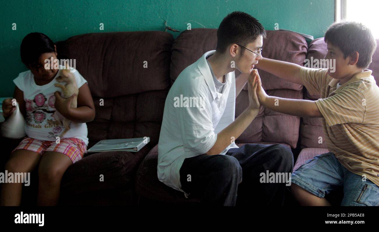 Jorge Vasquez-Godinez, 18, center, plays with his brother Uriel, 10, as ...