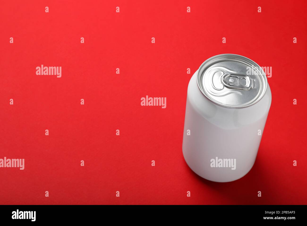 White can of energy drink on red background. Space for text Stock Photo ...