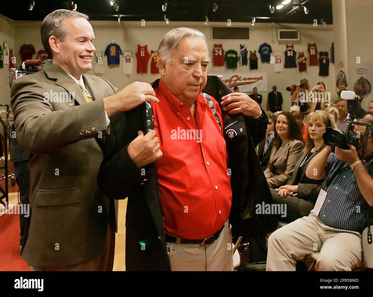 Pedro Ferrandiz, coach of Real Madrid, has his Basketball Hall of Fame jacket placed over his ...